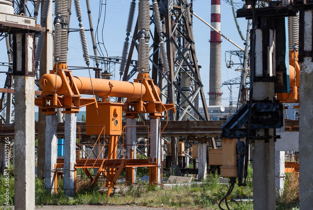 Transformer substation on blue sky background. Orange high-voltage ...