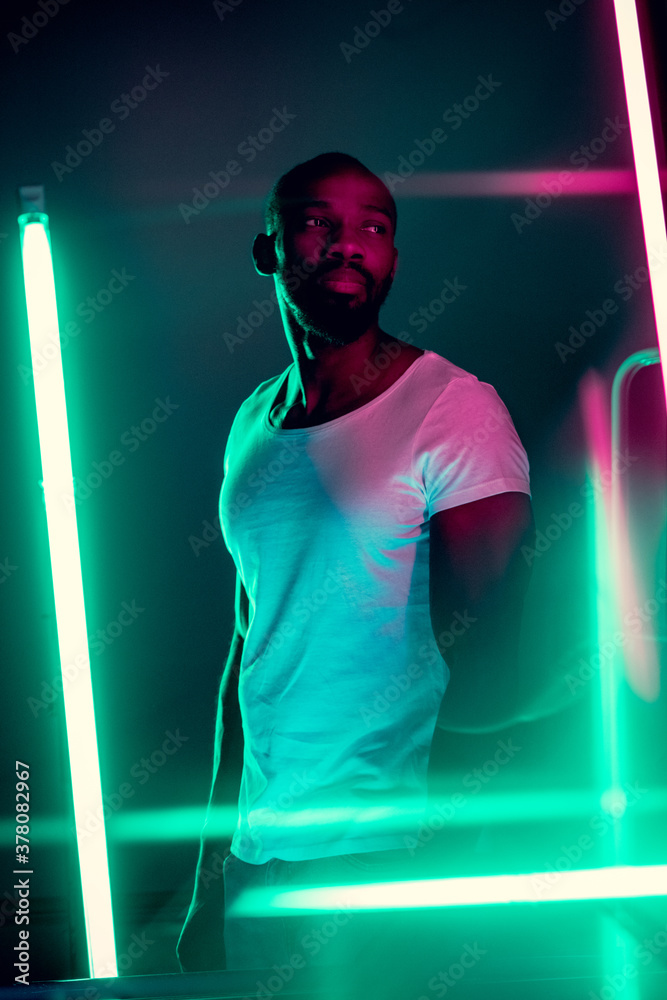 Geometric lines. Cinematic portrait of stylish young man in neon ...