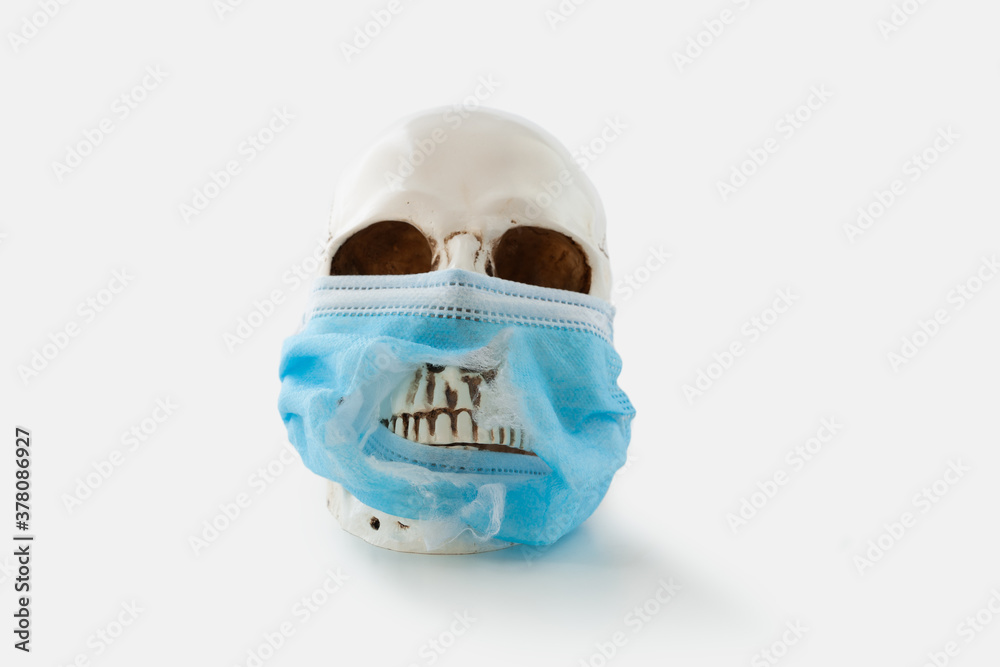 Human skull wearing blue surgical mask ripped and torn around the mouth ...