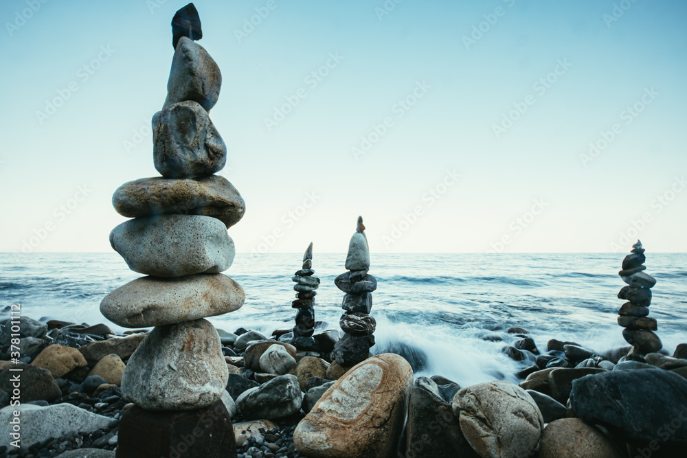 Zen style balanced stones on beach. Rock sculpture stone stacking. A ...