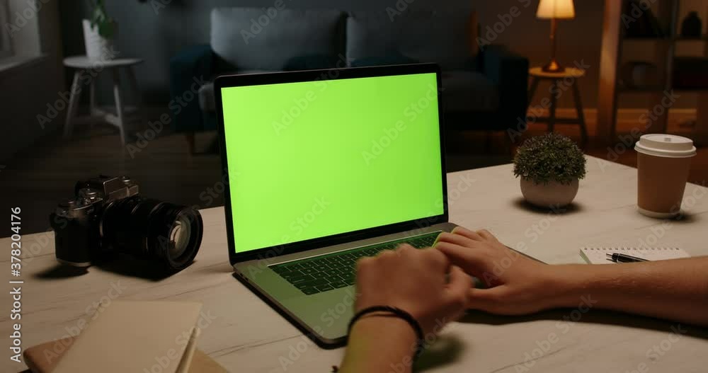 Close up shot of hands of a remote worker working on laptop computer ...