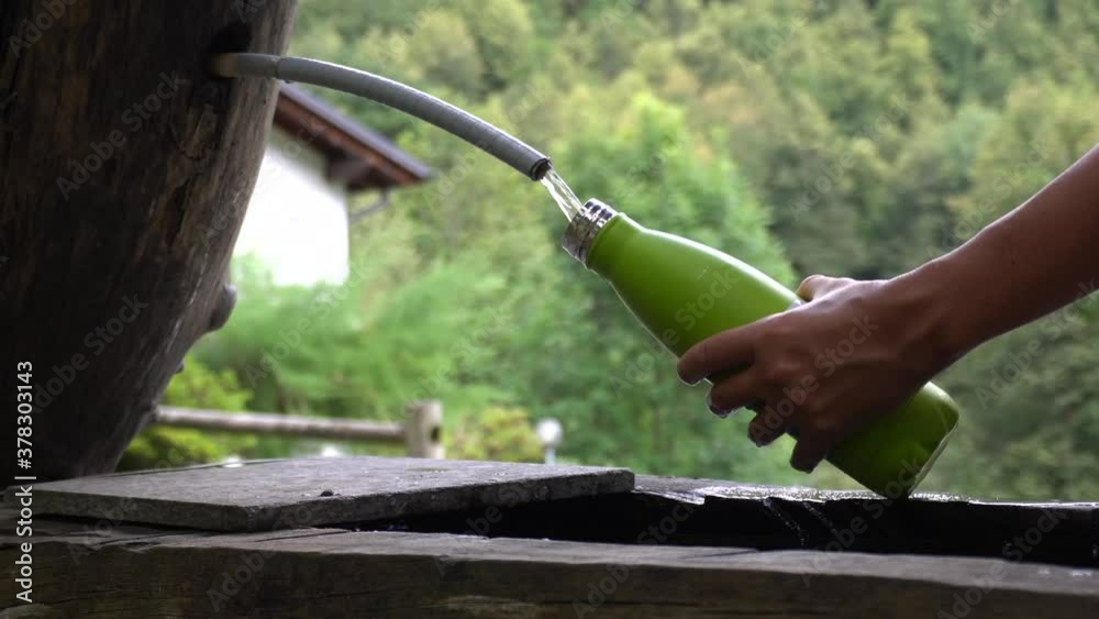 Italy , Alps Devero Piedmont - Mountain wooden fountain - hand filling ...