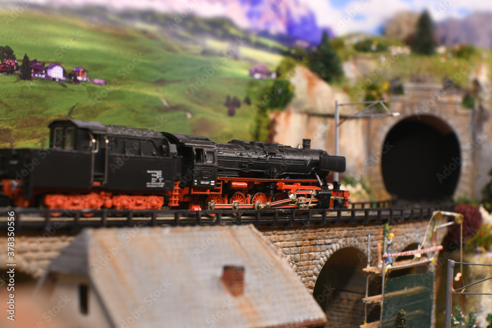 Miniature railway model with mountains landscape and steam locomotive ...