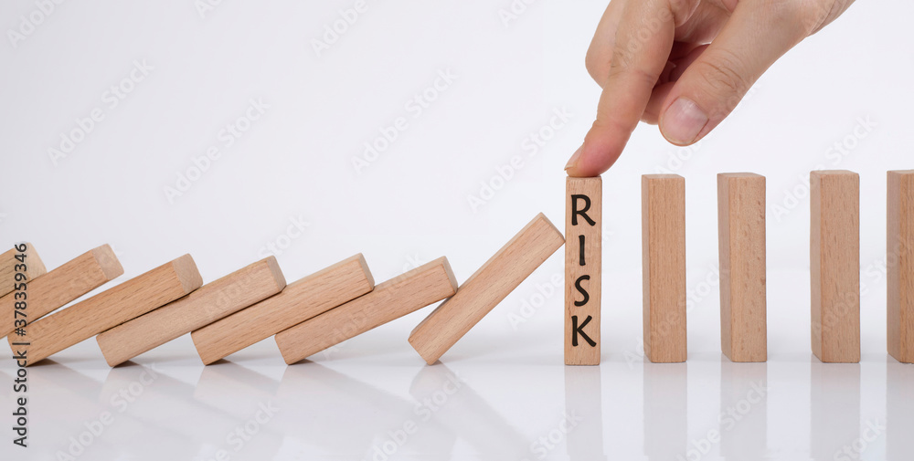 domino effect and risk management concept. manager stops falling wooden ...
