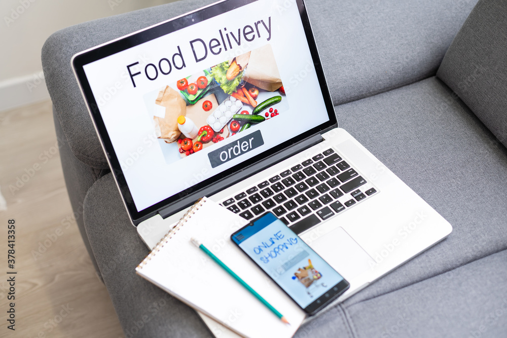 ordering food online concept: woman with a laptop showing fast food ...