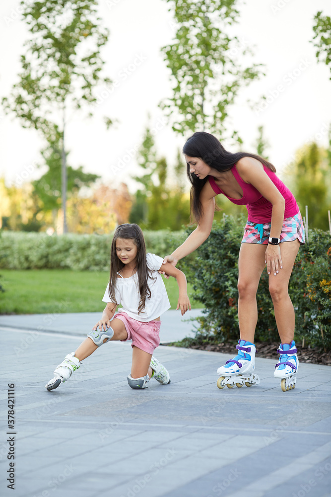 little child girl falled down while rolling with her mother in park ...