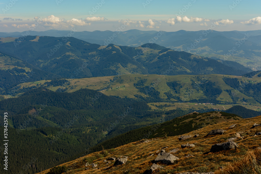 Beautiful landscape with high cliffs and illuminated peaks, blue sky ...