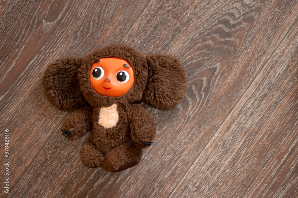 children's old toy cheburashka character from the cartoon lies on the ...