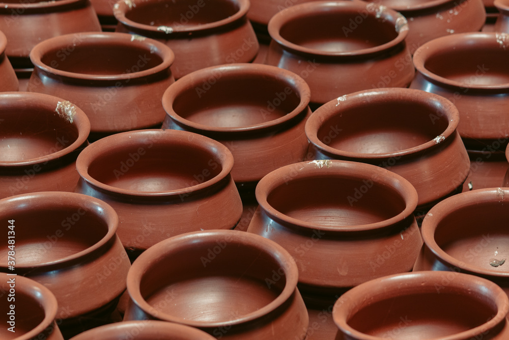 Row of unbaked clay terra cotta pots at traditional pottery shop near ...