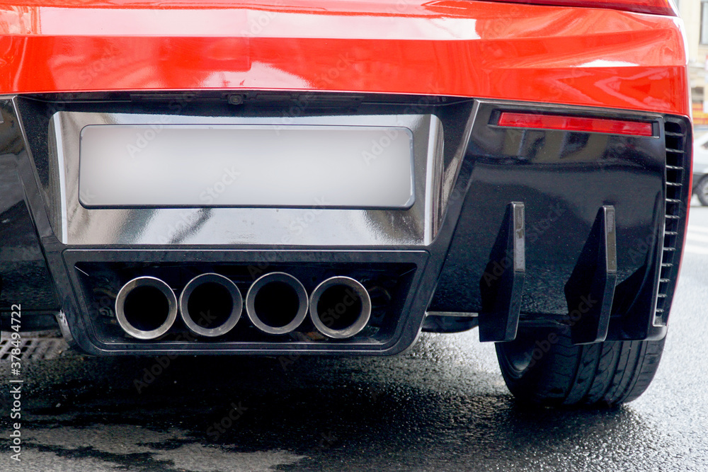 Four exhaust pipes of a powerful sports car. Stock Photo | Adobe Stock