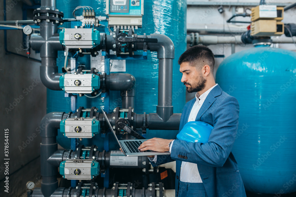 supervisor checking chemical water treatment equipment Stock Photo ...