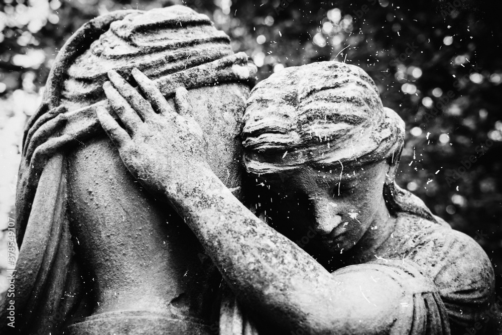 Retro styled image of an ancient statue of desperate woman on tomb as a ...
