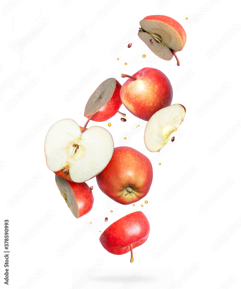 Whole and sliced fresh red apples in the air isolated on a white ...
