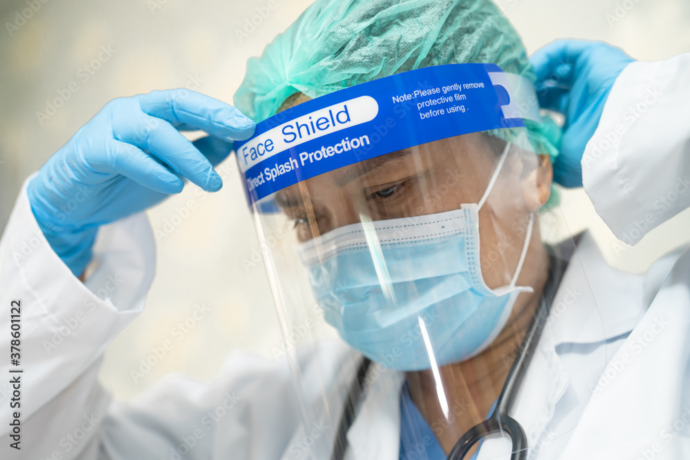 Asian doctor wearing face shield and PPE suit new normal to check ...