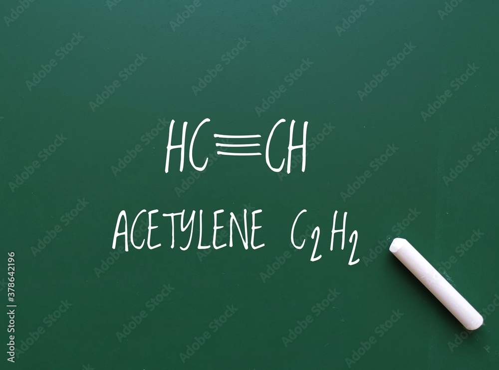 Structural chemical formula of acetylene molecule written on a green ...