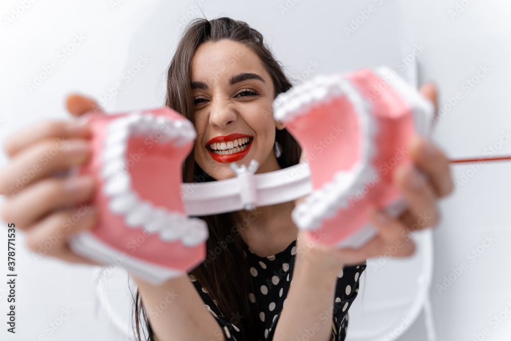 Funny girl with an opened dental jaw near face. Woman toing with ...