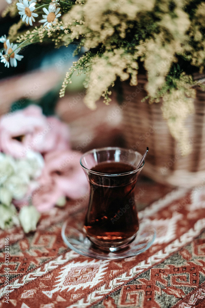 Tradition Turkish tulip shaped tea glass bardak with black tea on a ...