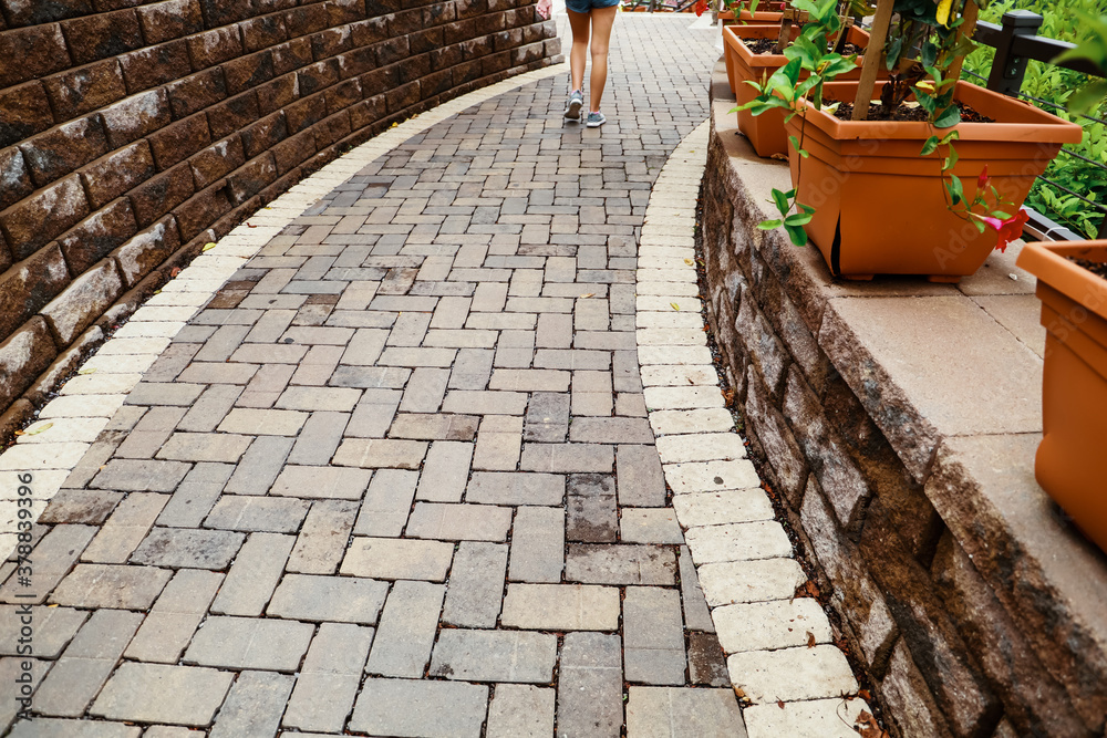 Weathered stone brick pathway on an outdoor patio walkway path with a ...