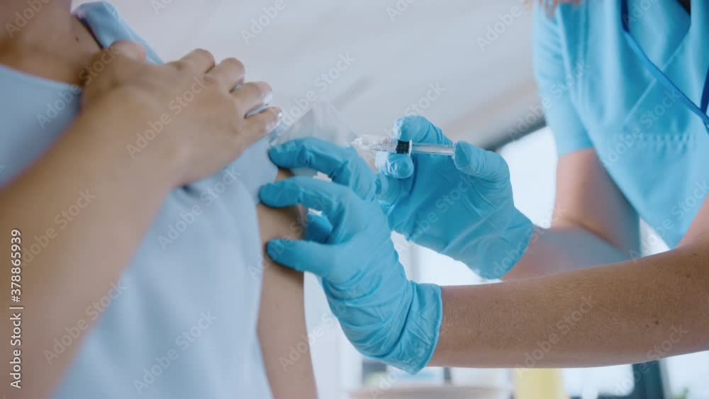 Medical Nurse in Safety Gloves and Protective Mask is Making a Vaccine ...