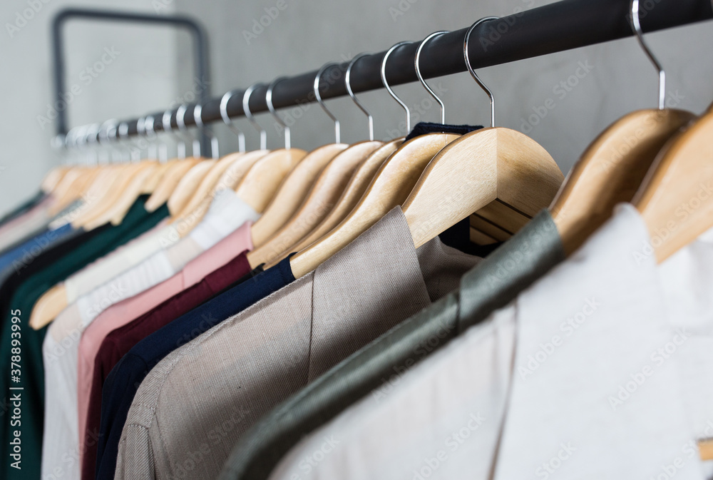 Collection of fashion clothes hanging on a clothing hanger rack in a ...