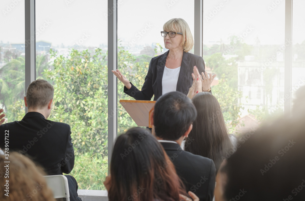 Senior business woman received applause from the audience while making ...