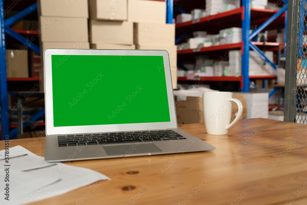 Computer with green screen display in warehouse storage room . Delivery ...