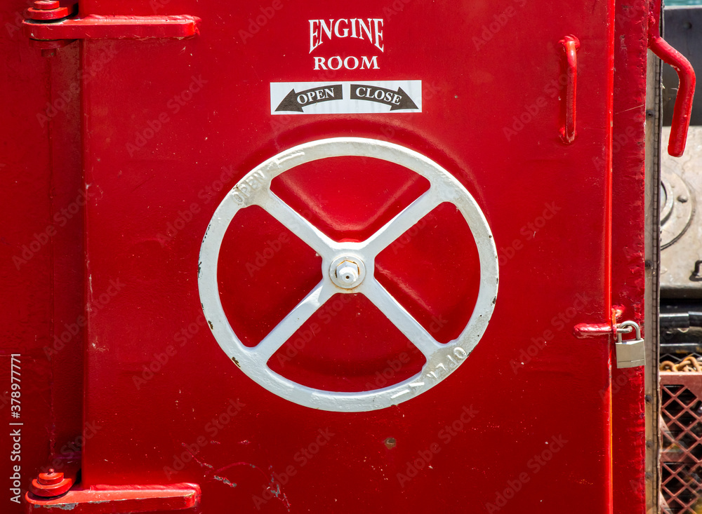the red engine room door with locking wheel of a tug boat Stock Photo ...
