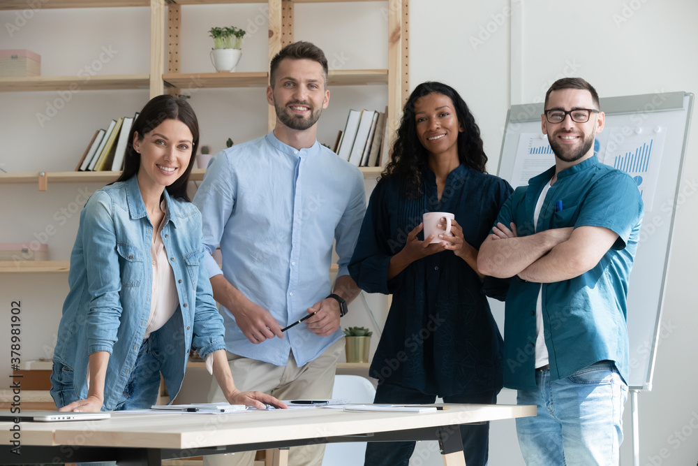 Smiling diverse employees standing in modern boardroom, group portrait ...
