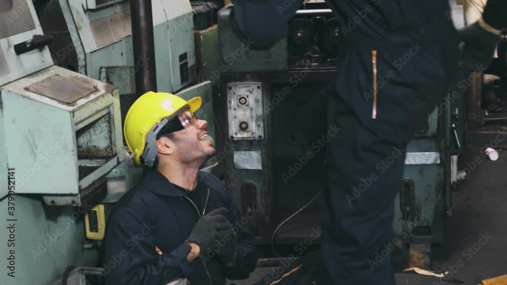 Factory worker injured by accident while using machine in factory in an ...