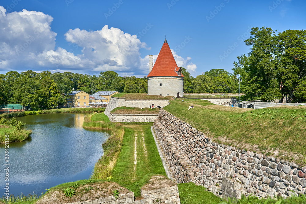 Old castle defense wall with a water canal around it and tower on the ...