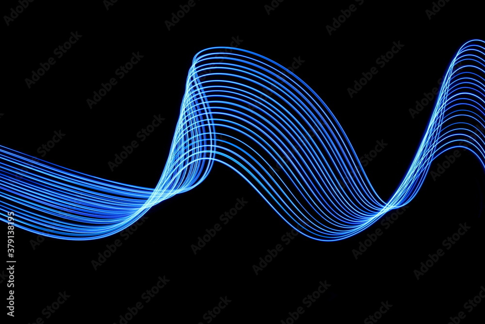 Long exposure photograph of neon blue colour in an abstract swirl ...
