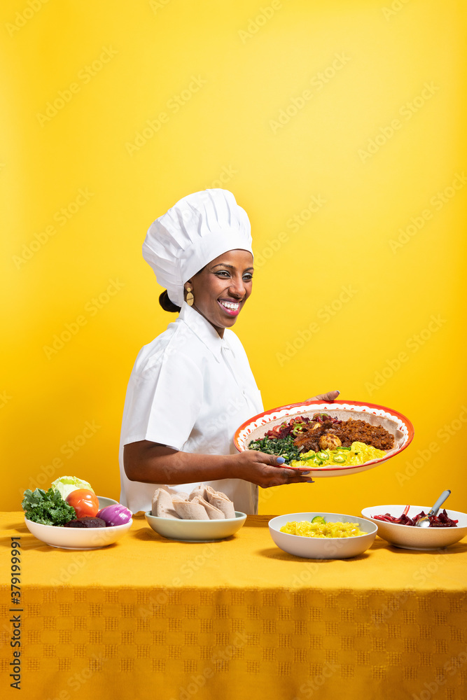 Beautiful Ethiopian chef with a table of Ethiopian food on bright ...