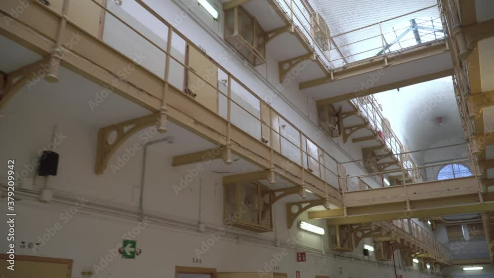 Overview of a prison or jail interior. Bridges and aisles between ...