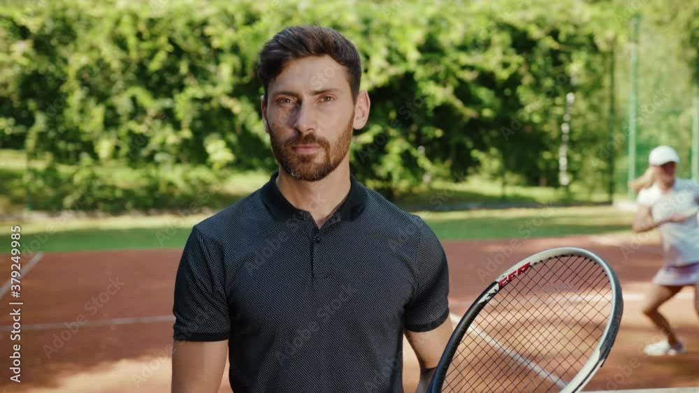 Handsome young tennis player man look at camera smiling on outdoor ...