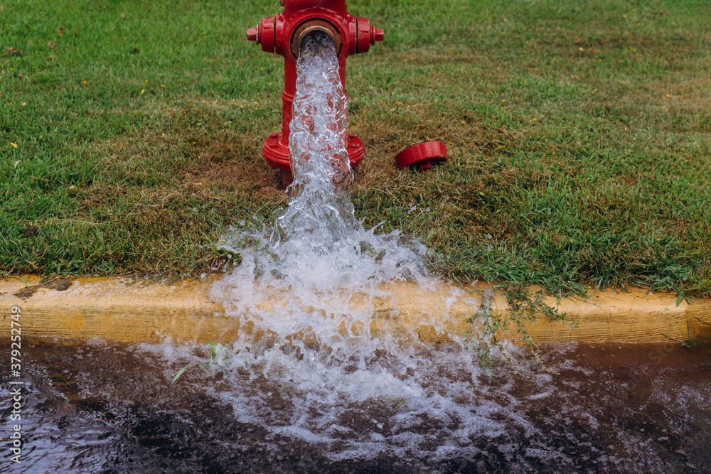 Open fire hydrant water flowing from open fire hydrant on street and ...