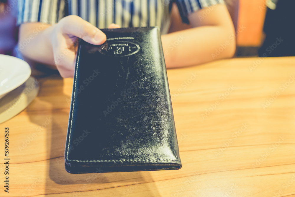 The customer's hand receives a bill and receipt from the waitress for ...
