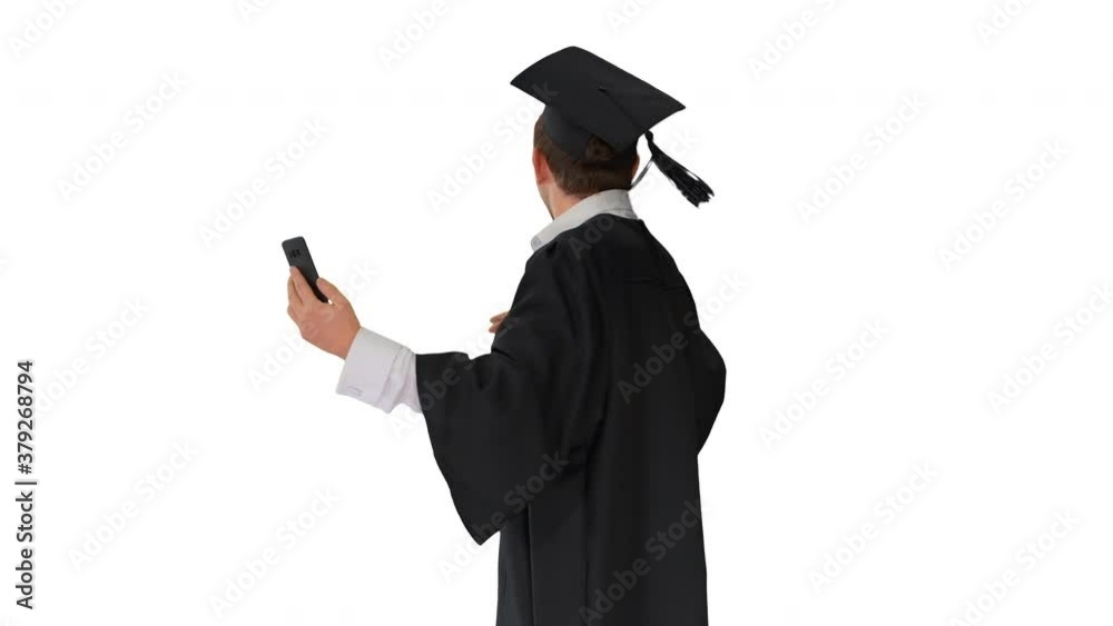Smiling male student in graduation gown showing campus via video call ...