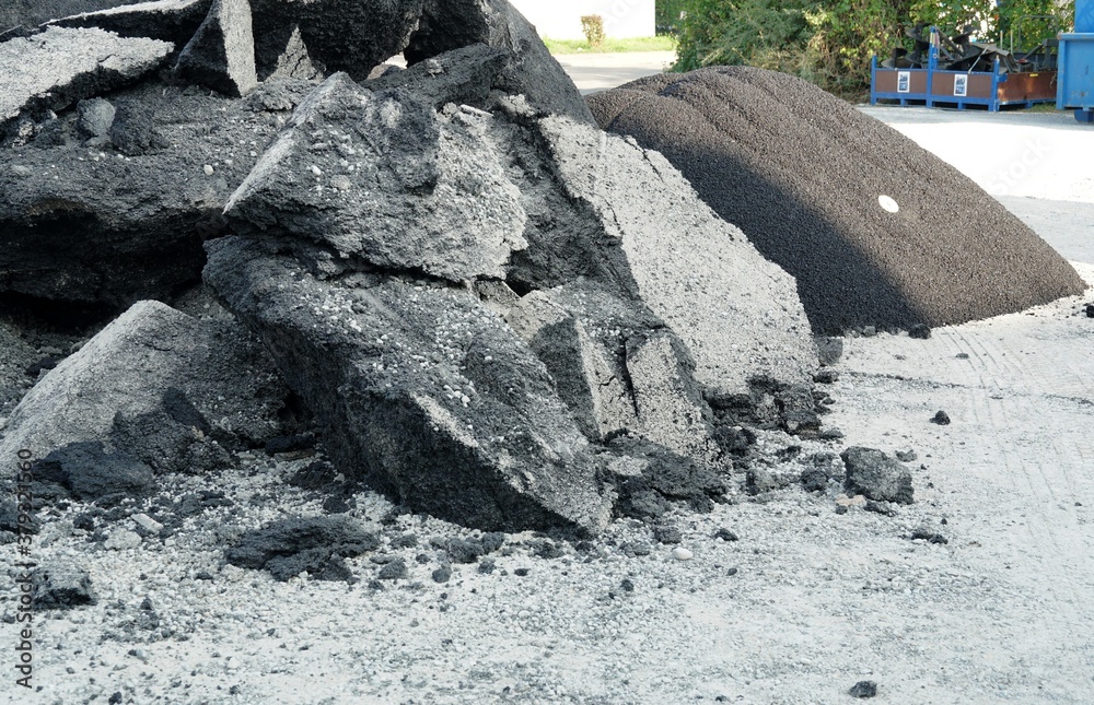 Broken big parts of damaged asphalt coat and crushed stones from old ...