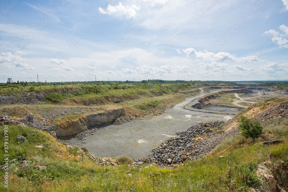 Big open pit limestone quarry mine with working drilling machines ...