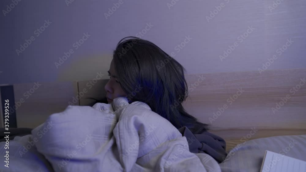 young Asian woman scared of lighting thunder loud noise, dive into ...