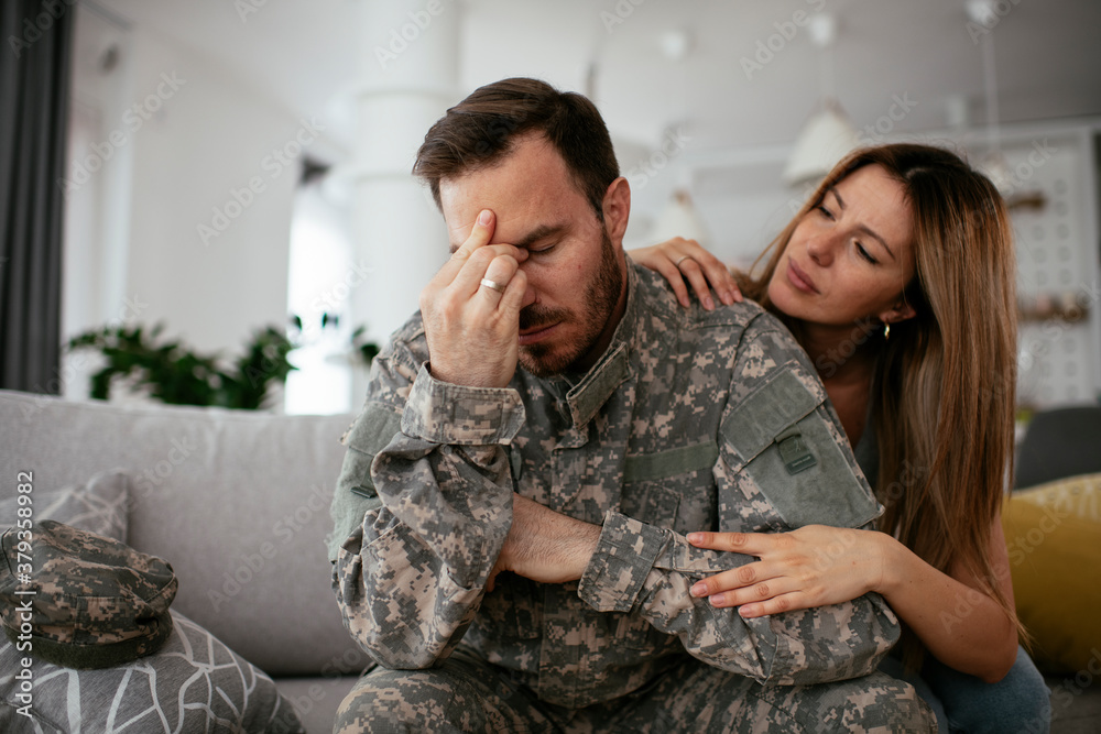 Depressed soldier sitting on sofa with his wife. Young marine having PTSD.. Stock Photo | Adobe ...