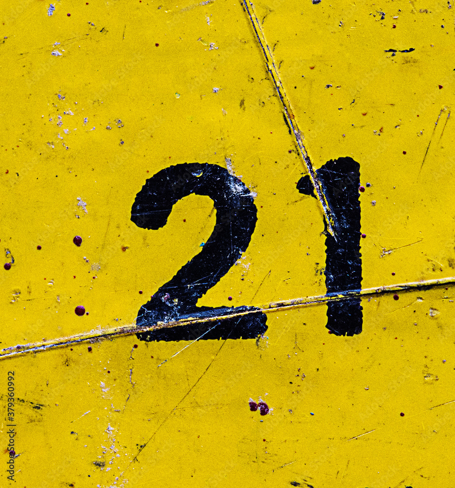 The number 21 is black on a yellow background. Grunge style, scratches ...