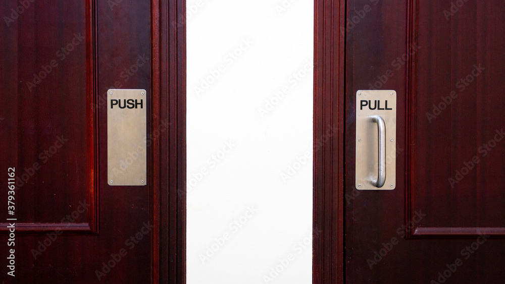 Push and pull sign on a wooden door Stock Photo | Adobe Stock