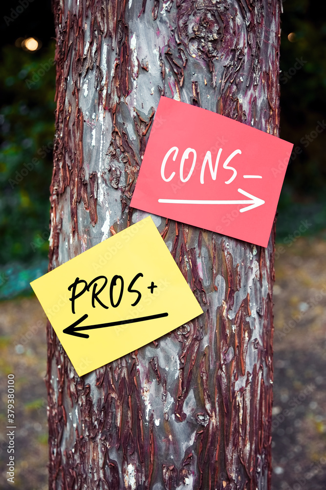 Pros and cons words written on papers on a tree with arrow signs ...