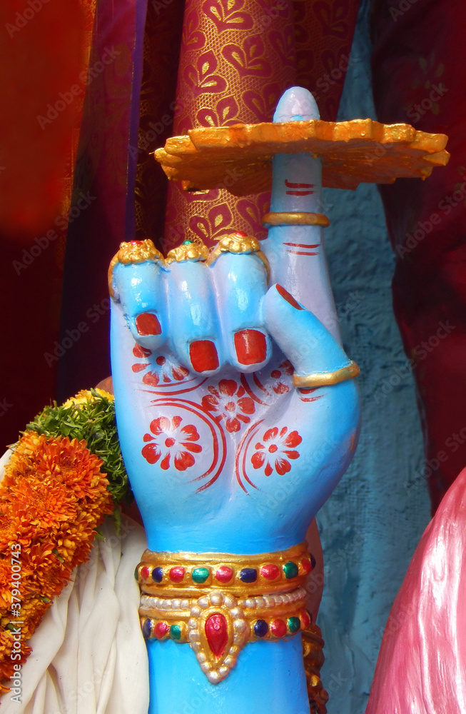 Hand of Hindu god Vishnu statue with weapon chakra Stock Photo | Adobe ...