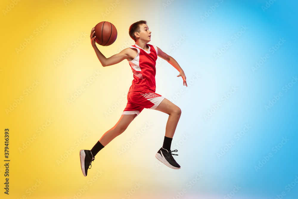 Jump high. Full length portrait of young basketball player in uniform ...