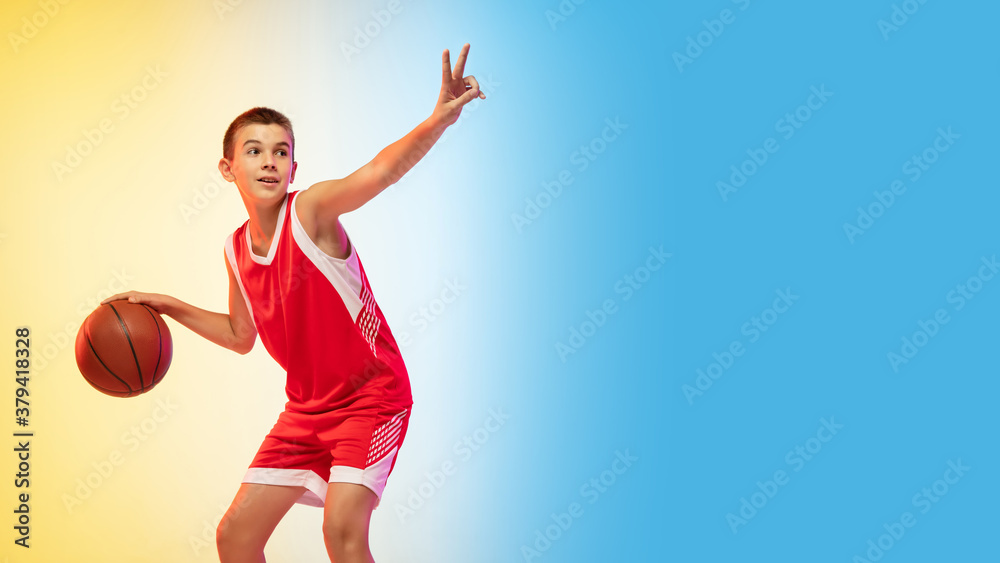Game. Portrait of young basketball player in uniform on gradient studio ...