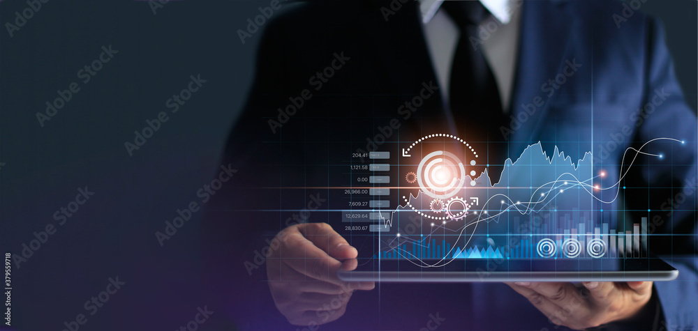 Businessman using tablet analyzing sales data and economic growth graph ...