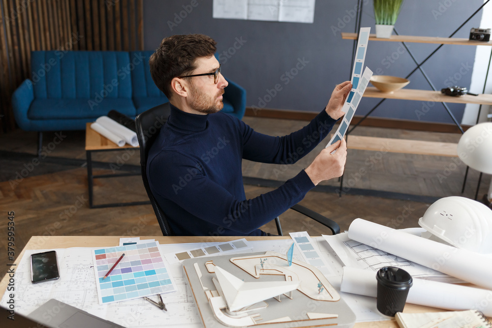 Architect working in office with color palette. Engineer select colors ...