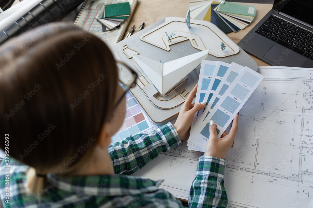 Female interior designer working in office with color palette ...